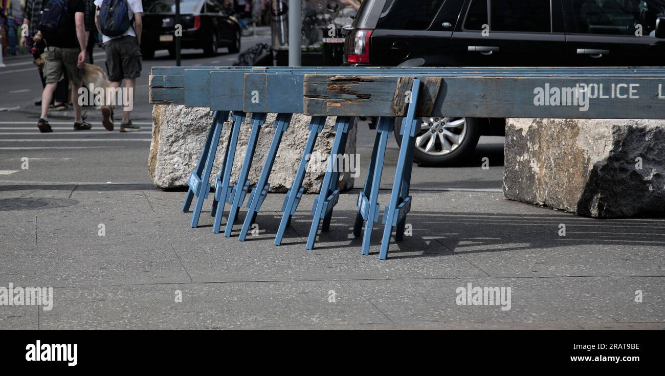 police barricades stacked on a sidewalk next to an intersection ...
