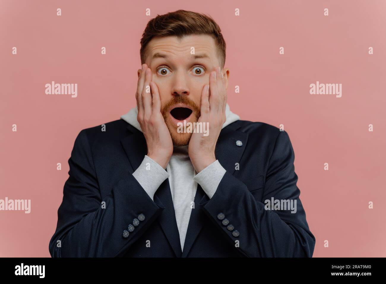 Shocked red-haired guy in casual wear, amazed expression, receiving ...