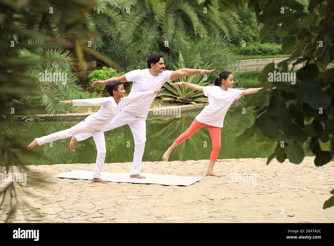 Trainer exercising and teaching kids the yoga poses in green ...