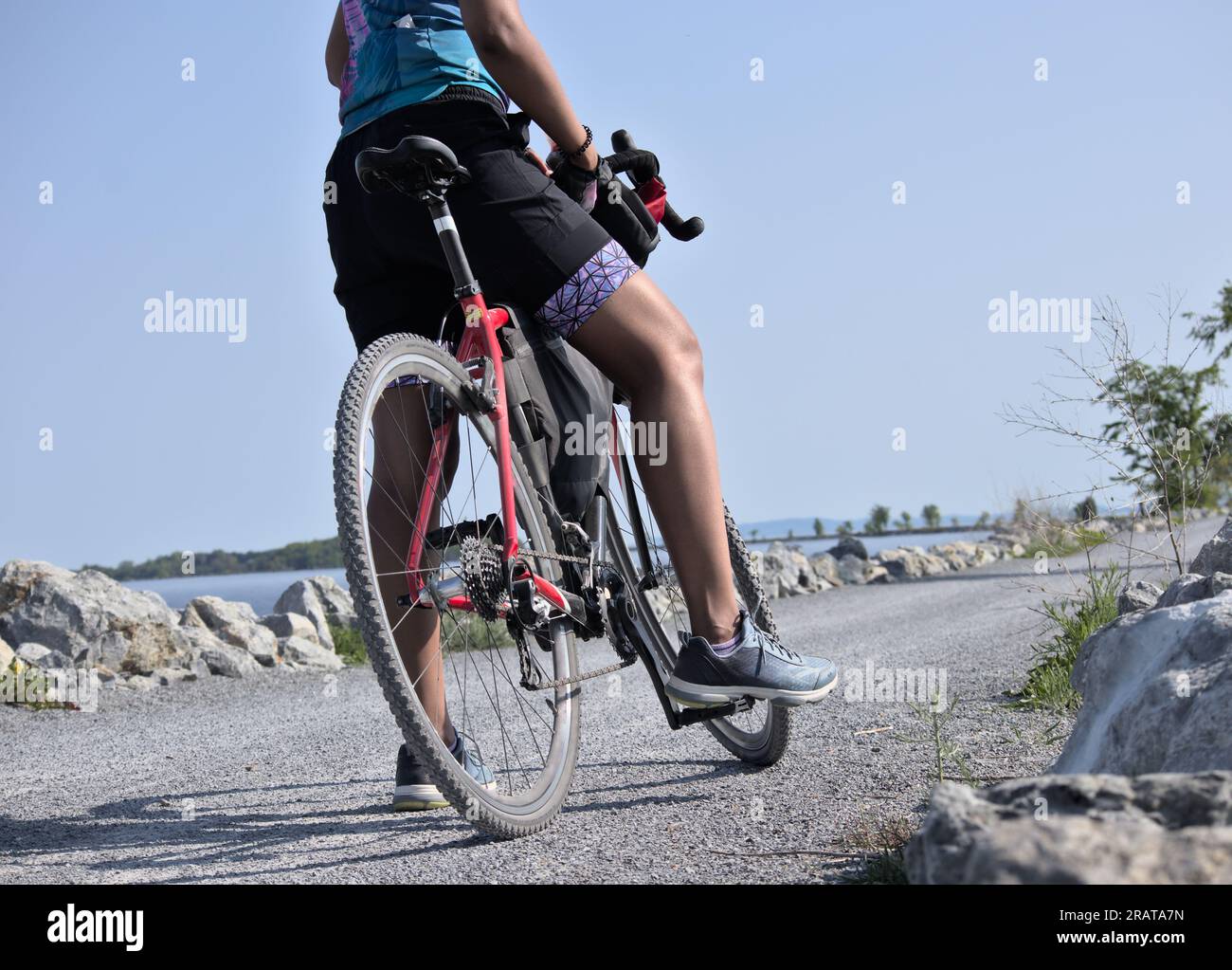 woman riding bike on gravel trail (young south asian, indian rider on ...