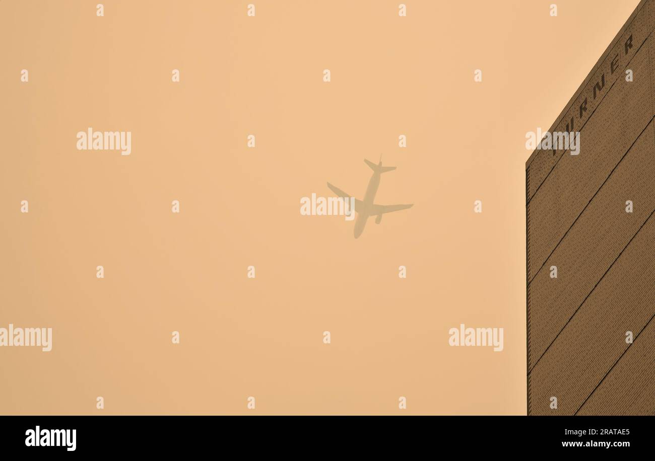 airplane flying in smoke filled sky, brooklyn, new york city (hazy ...