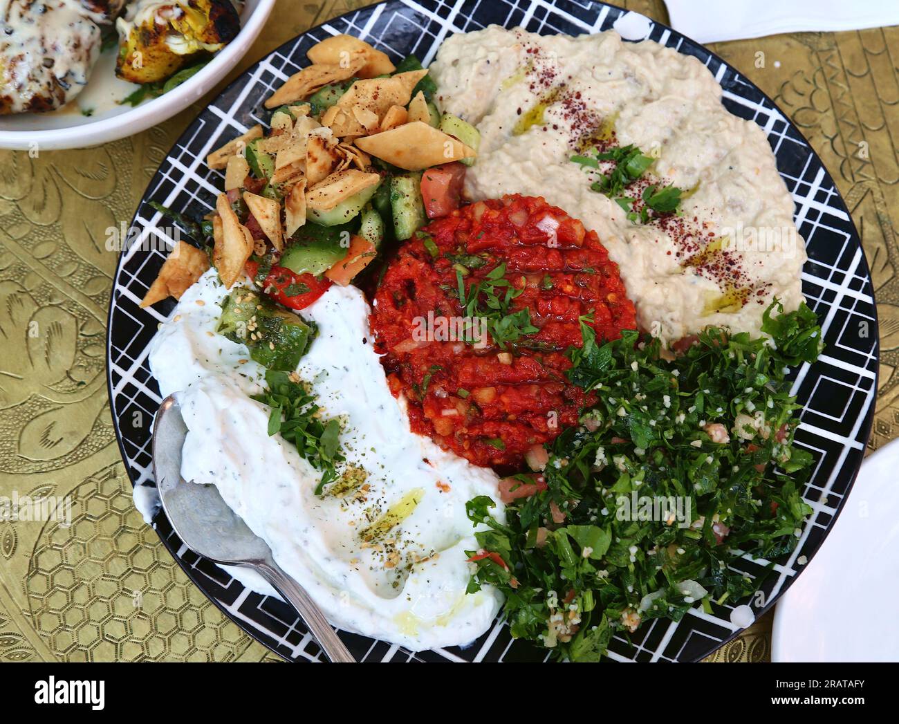Mediterranean mixed appetizers plate (hummus, baba ghanoush, ezme, tabbouleh, labneh, yogurt ...