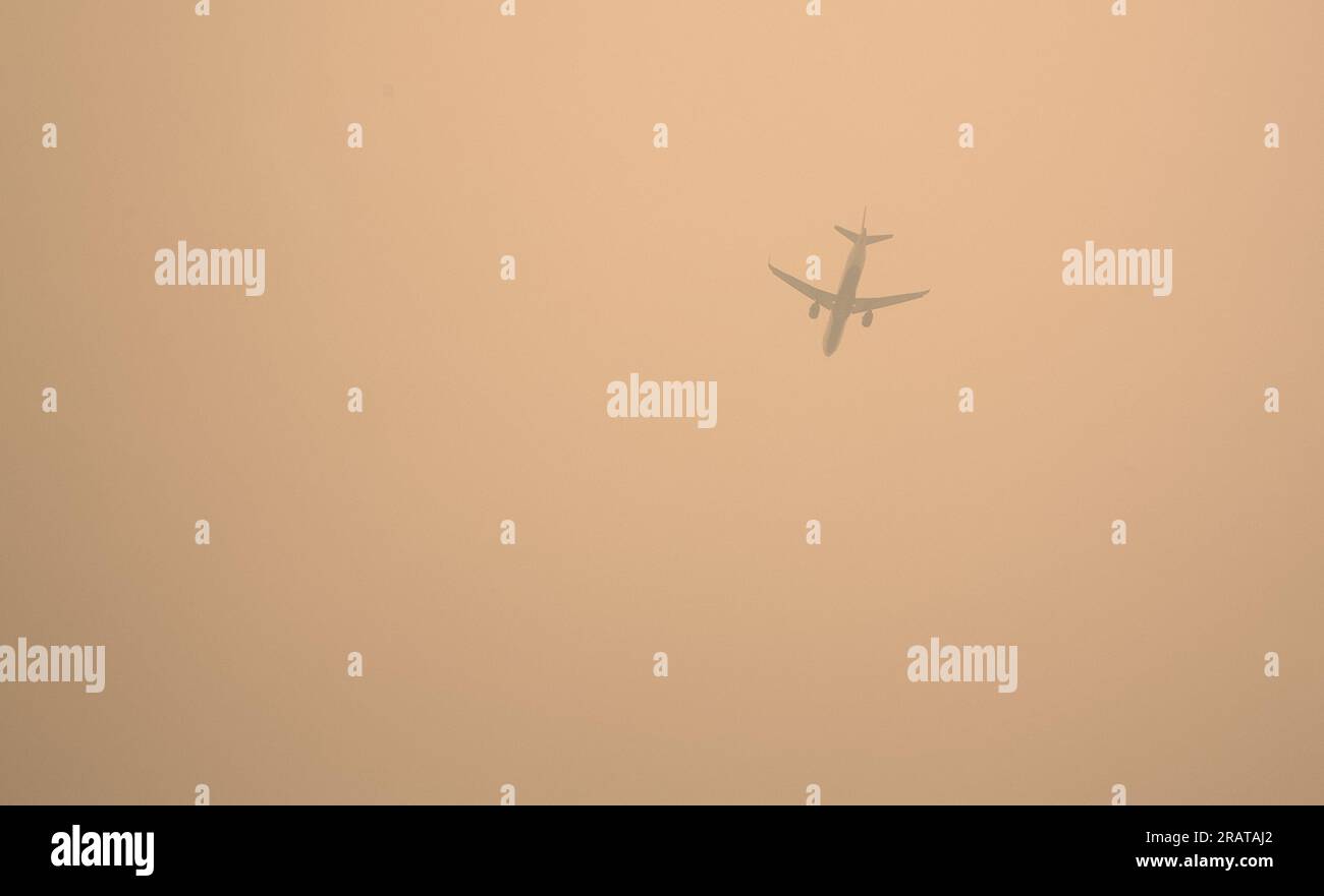 airplane flying in smoke filled sky, brooklyn, new york city (hazy ...