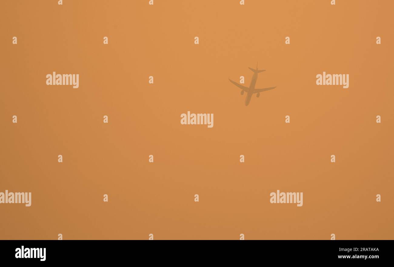 airplane flying in smoke filled sky, brooklyn, new york city (hazy ...