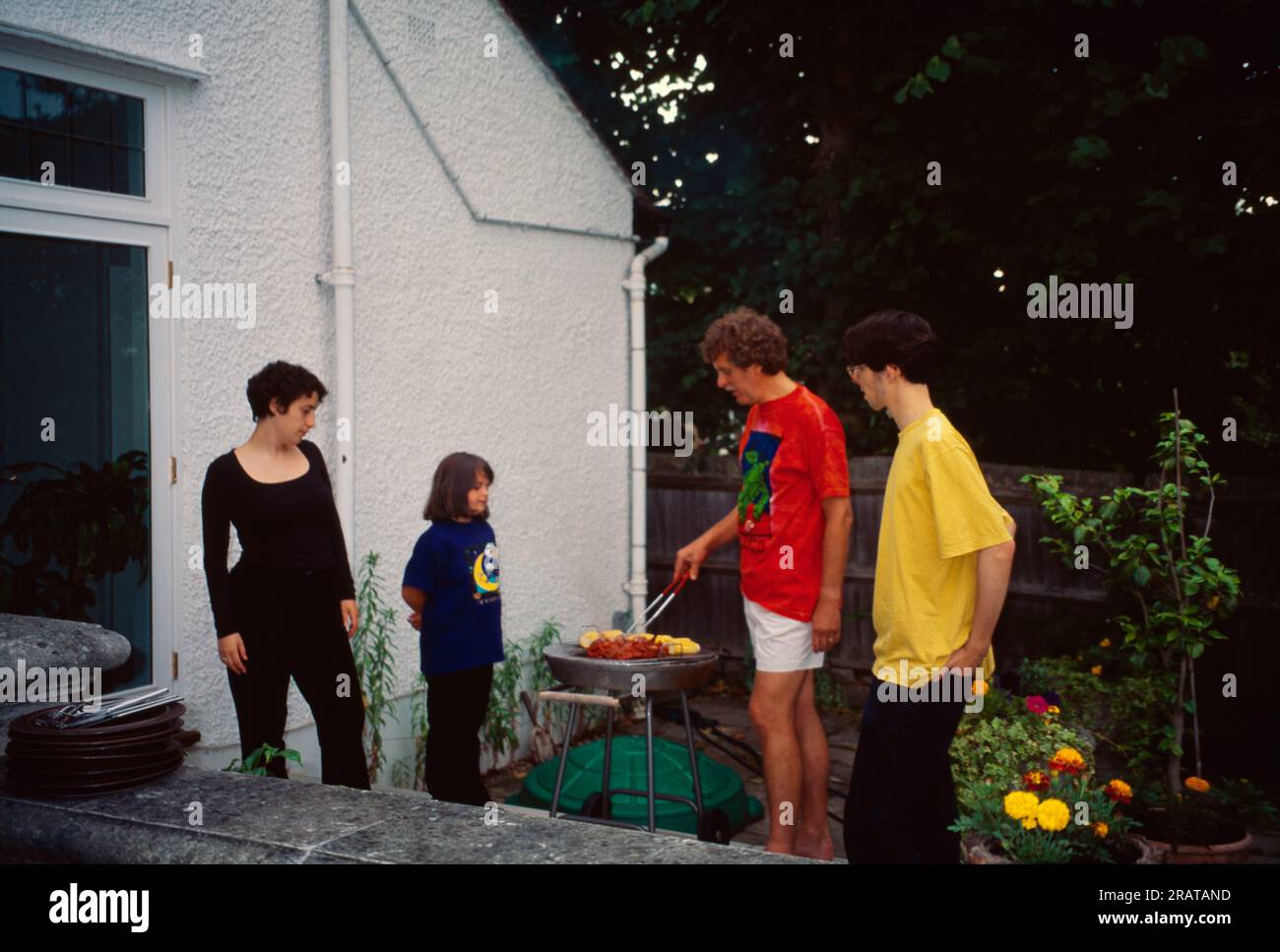 Family Having Barbecue in Garden Surrey England Stock Photo - Alamy