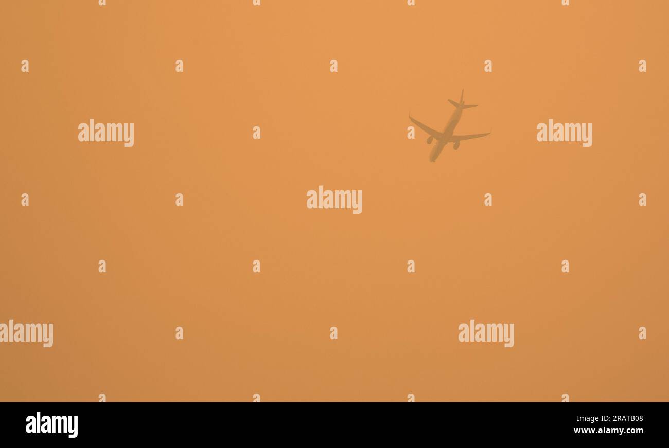 airplane flying in smoke filled sky, brooklyn, new york city (hazy ...