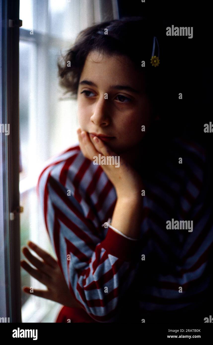 12 Year Old Girl Looking out of Window Thoughtful England Stock Photo ...