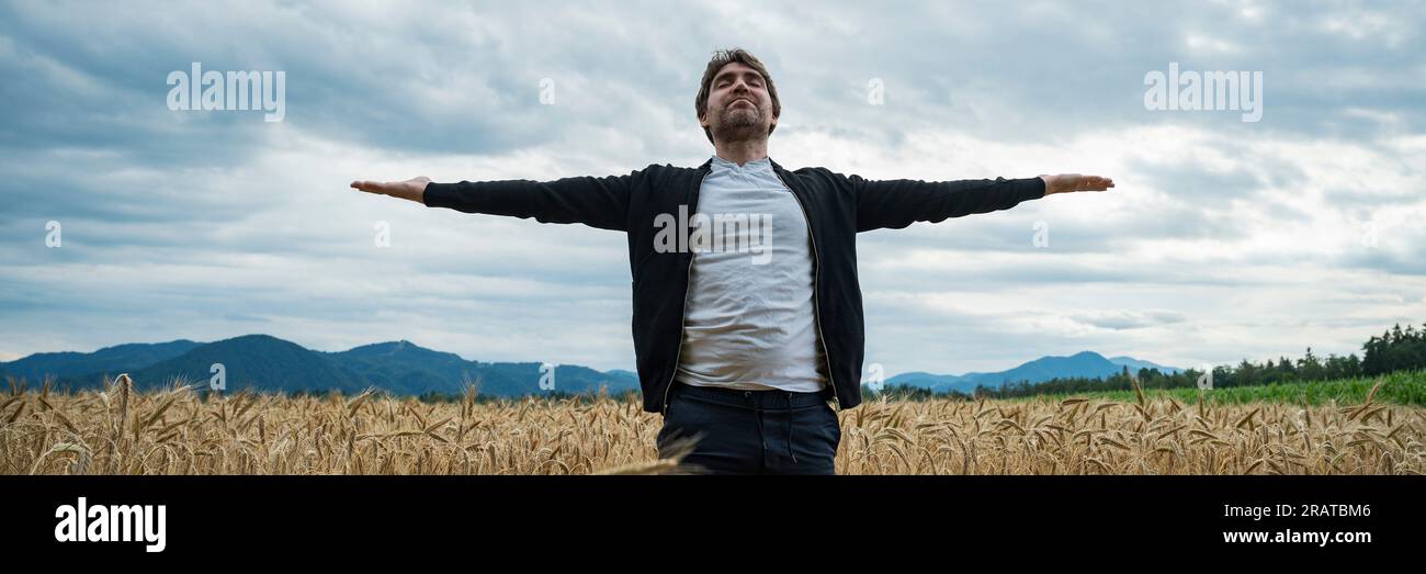 Wide view image of peaceful young man practicing mindfulness or ...