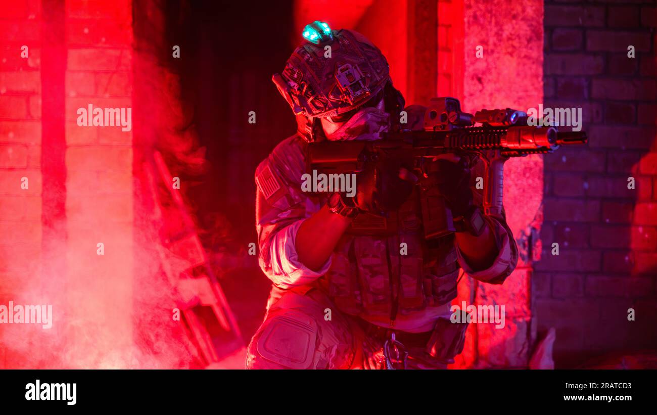 Expert team of soldiers with weapons attacking enemy during military ...