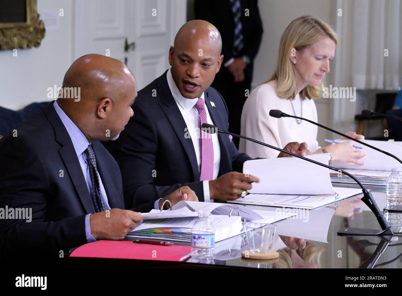 Maryland Gov. Wes Moore, center, talks to Treasurer Dereck Davis during ...