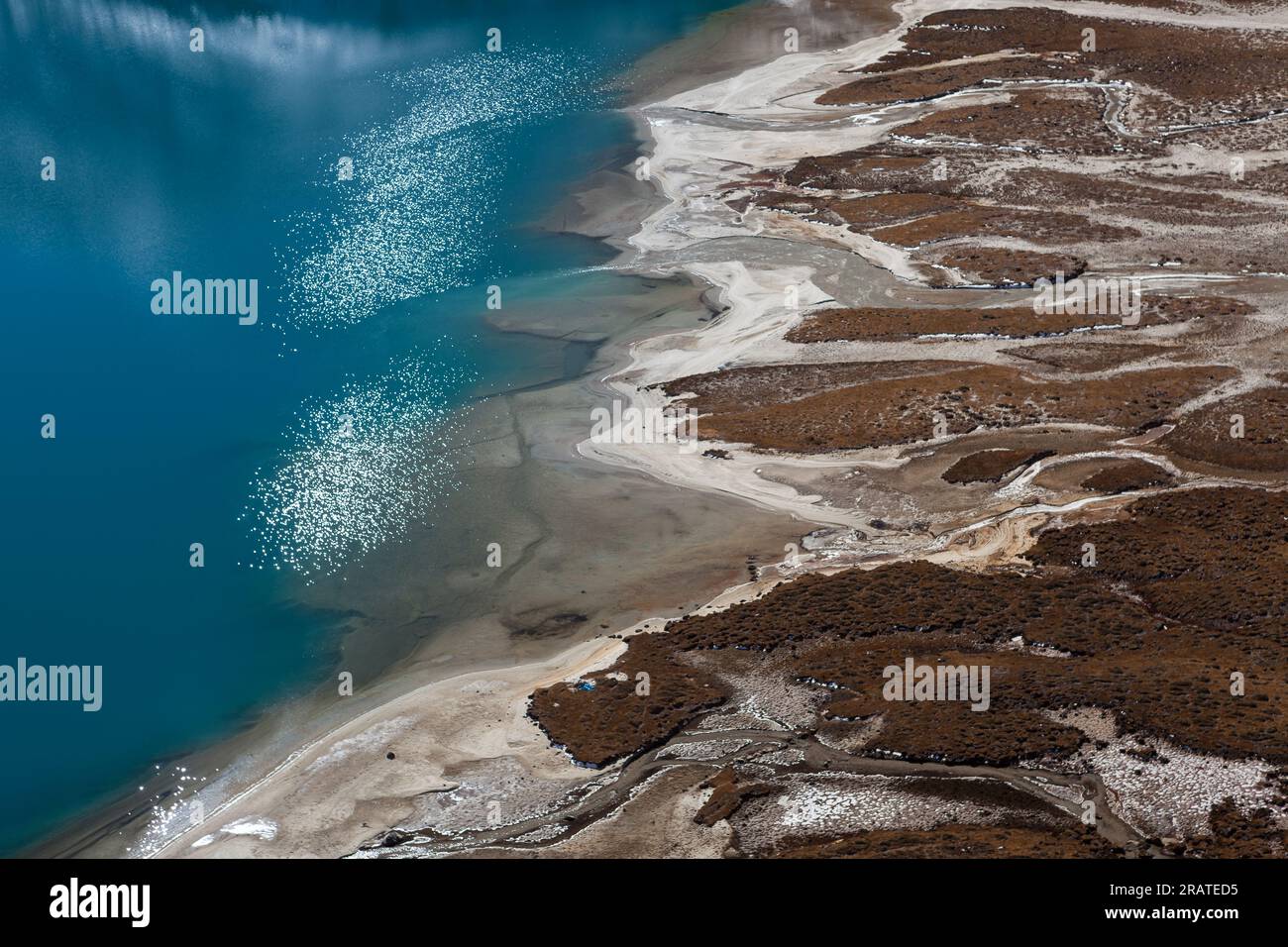 Aerial view of Gokyo Lake turquoise waters and white sand beach shore ...