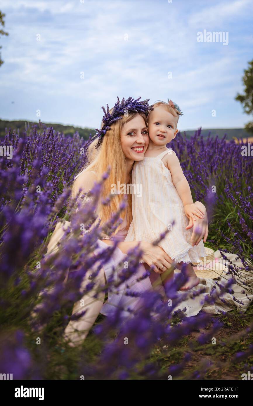 mom hugs her daughter. family picnic on a lavender field Stock Photo - Alamy