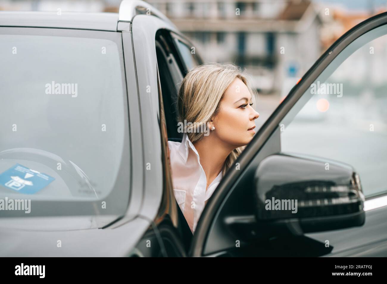 Beautiful blonde girl sitting hi-res stock photography and images - Alamy