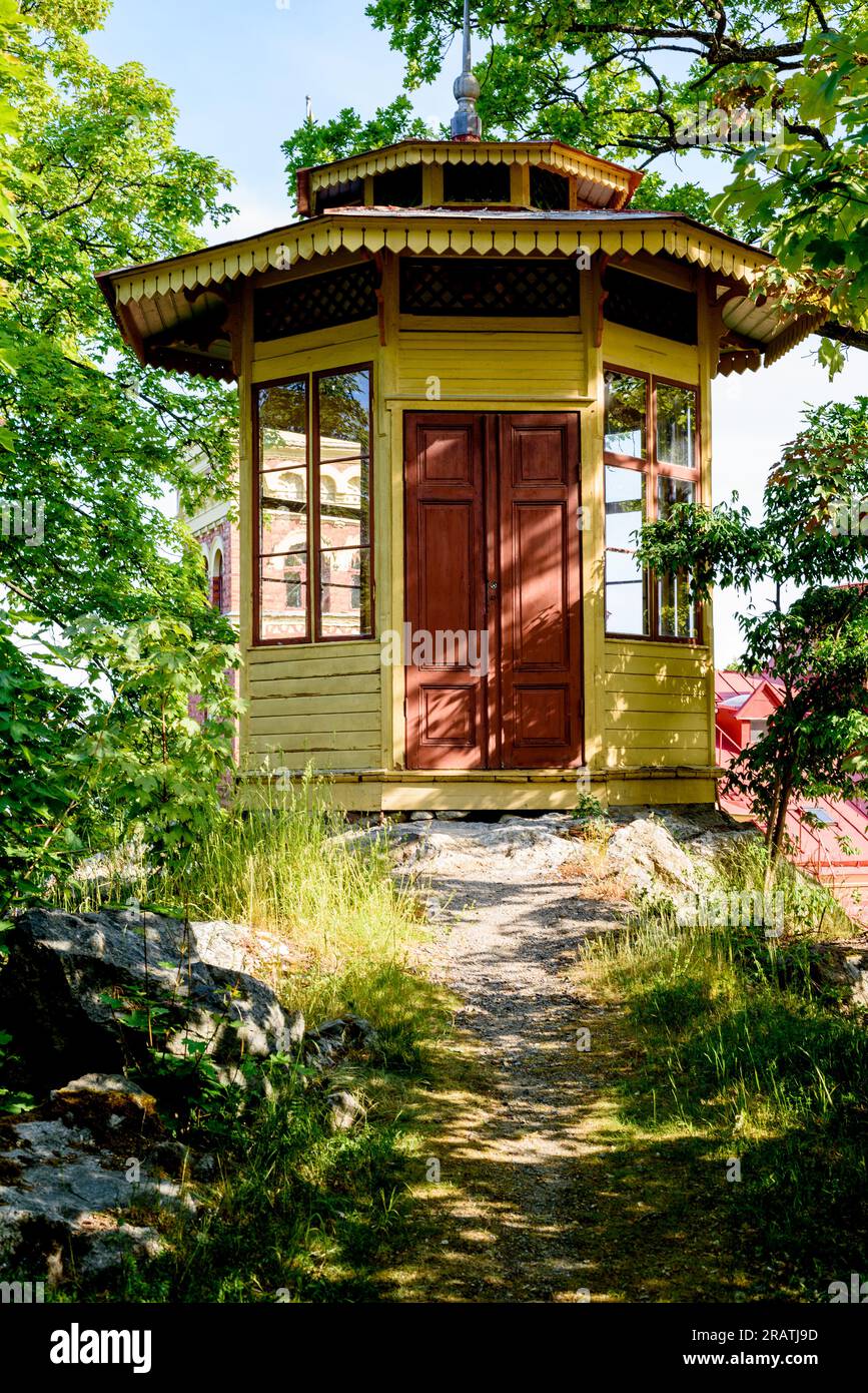 An old round gazebo on the embankment. Old architecture. Wooden yellow ...