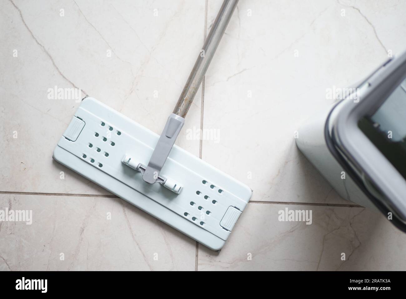 cleaning tiles floor with mop Stock Photo - Alamy