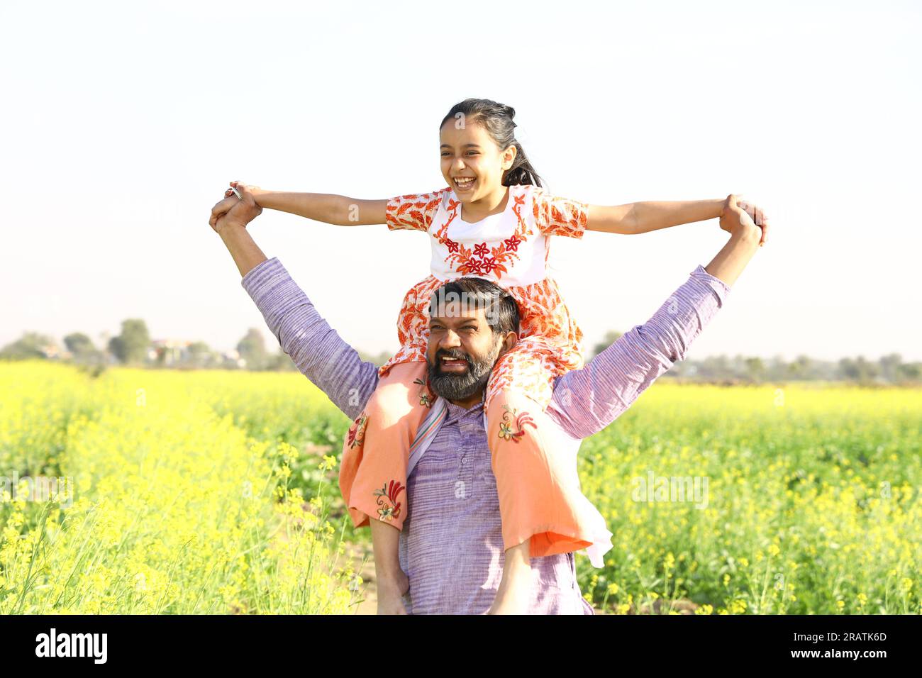 Indian rural happy farmers. Father and daughter in mustard field ...