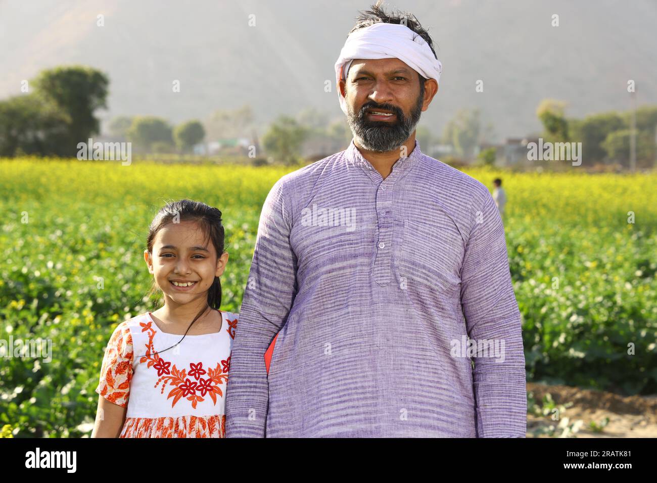 Indian rural happy farmers. Father and daughter in mustard field ...