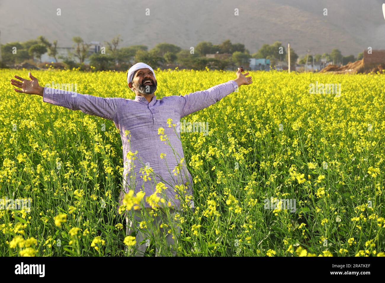 Portrait of Happy Indian farmer feeling the wind while standing in ...