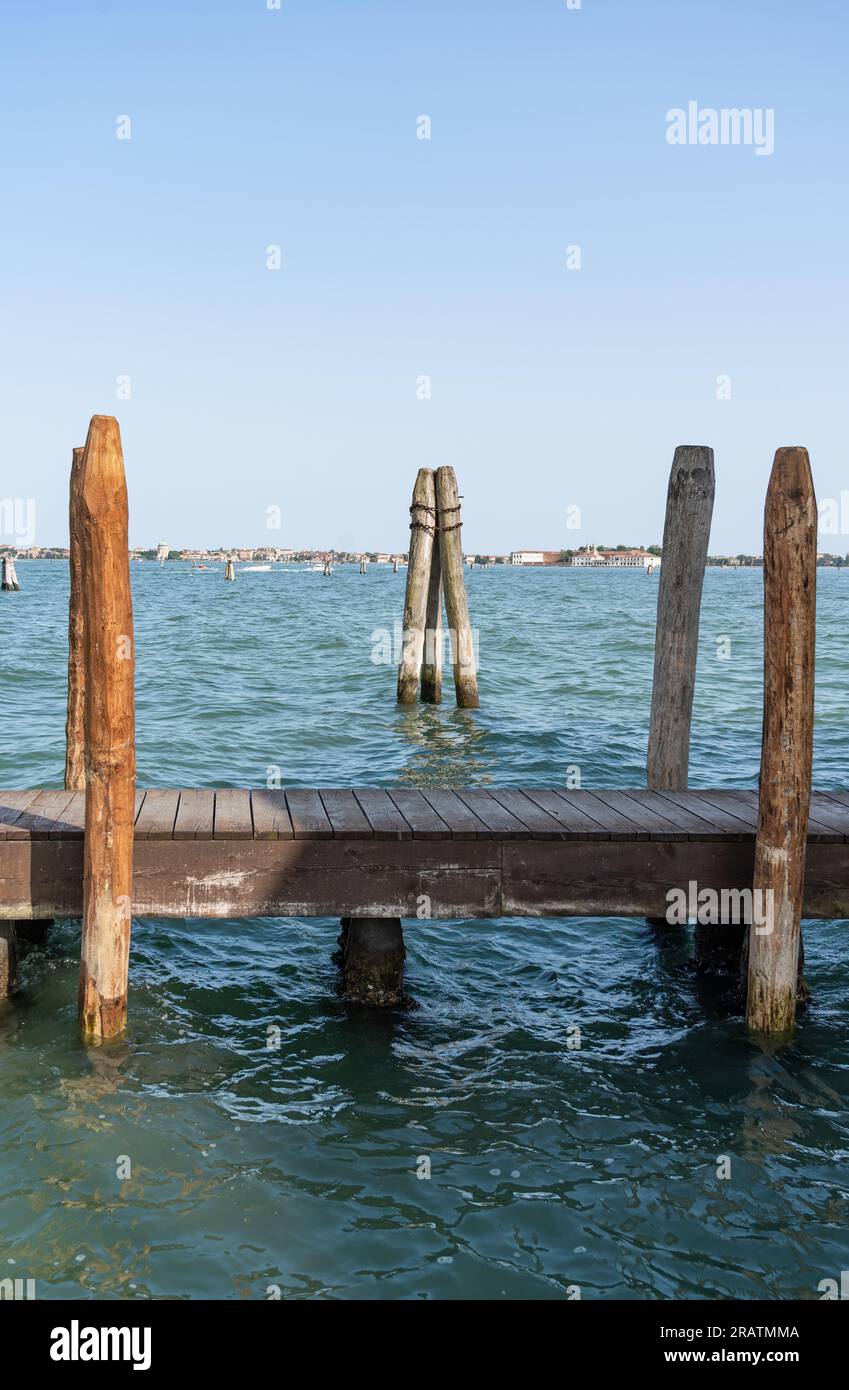 A wooden mooring pier and mooring piles on the Grand Canal in Venice ...