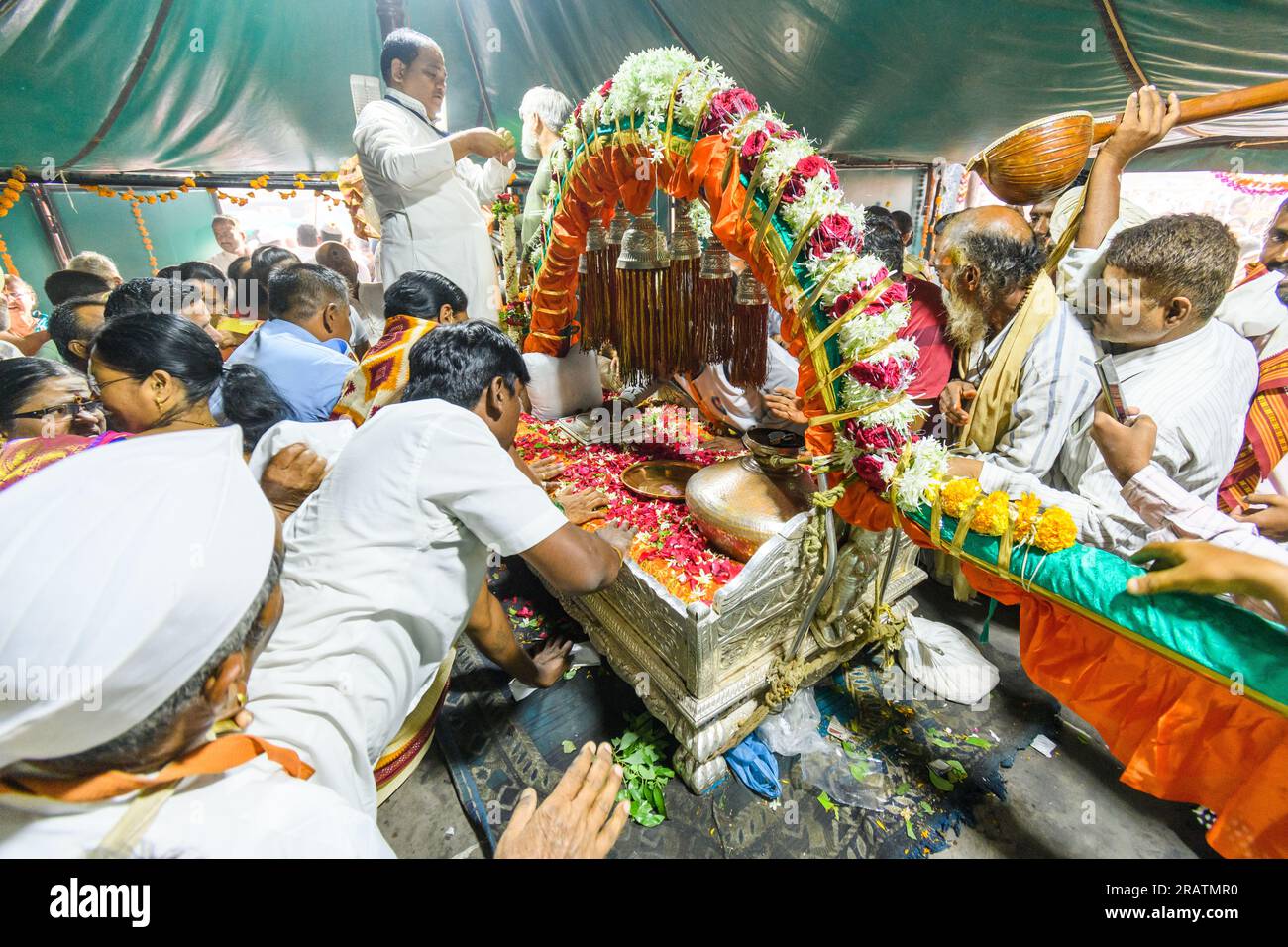 Wide closeup shot of warkari and common people having darshan and ...