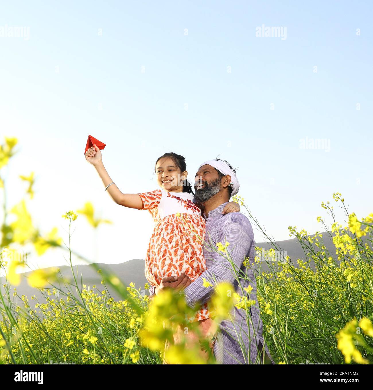Indian rural happy farmers. Father and daughter in mustard field ...