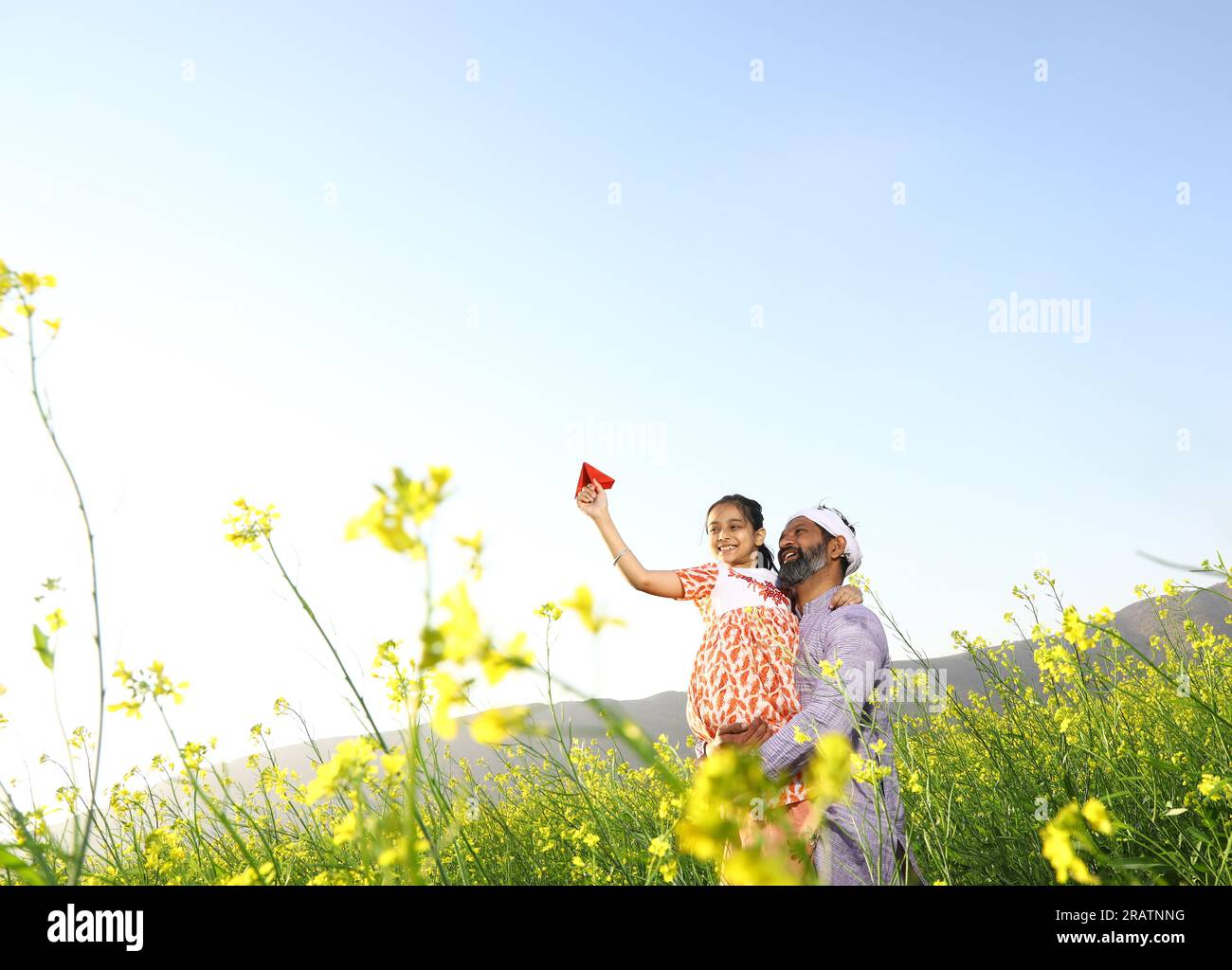 Indian rural happy farmers. Father and daughter in mustard field ...