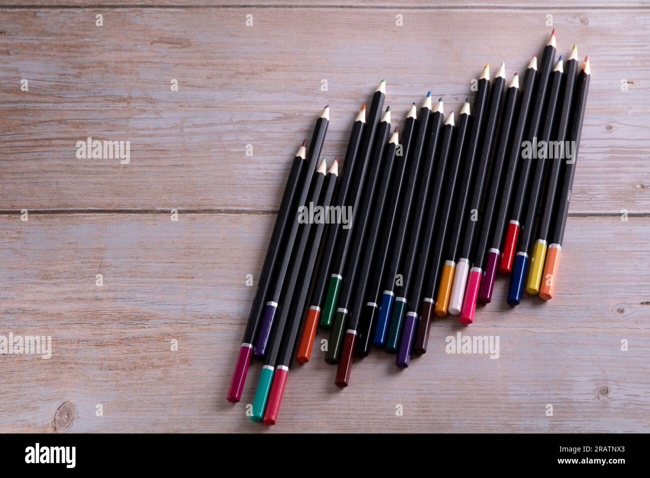 photo multicolored pencils on the table top view Stock Photo - Alamy