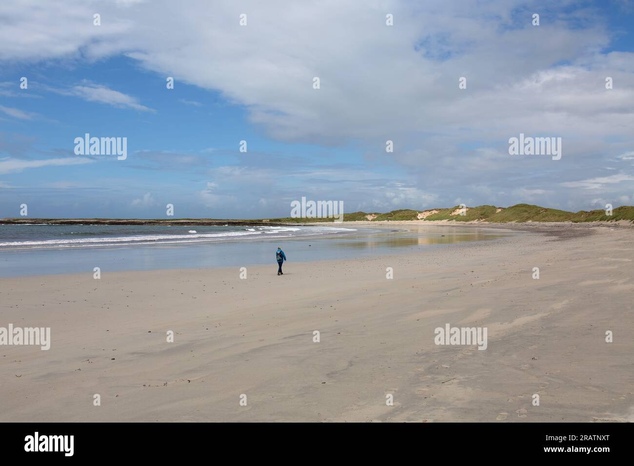 Female Walker walking on Culla Bay Beach, Benbecula, Uist, Hebrides ...