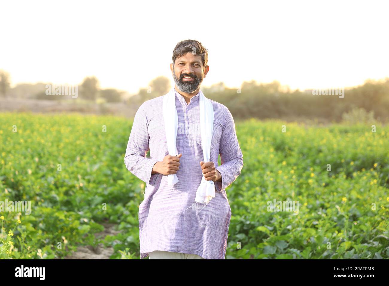 Portrait of Happy Indian farmer feeling the wind while standing in ...