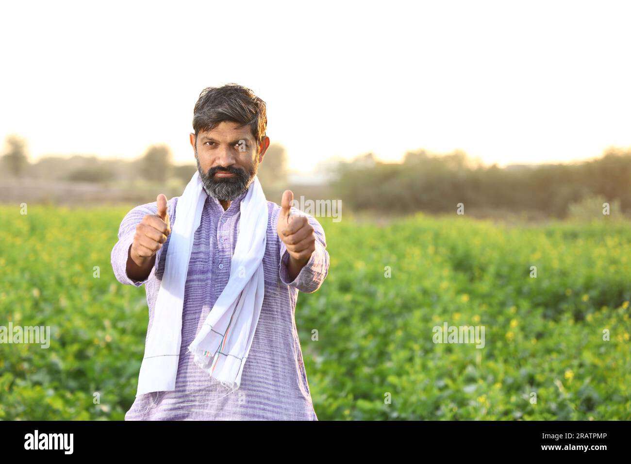 Portrait of Happy Indian farmer feeling the wind while standing in ...