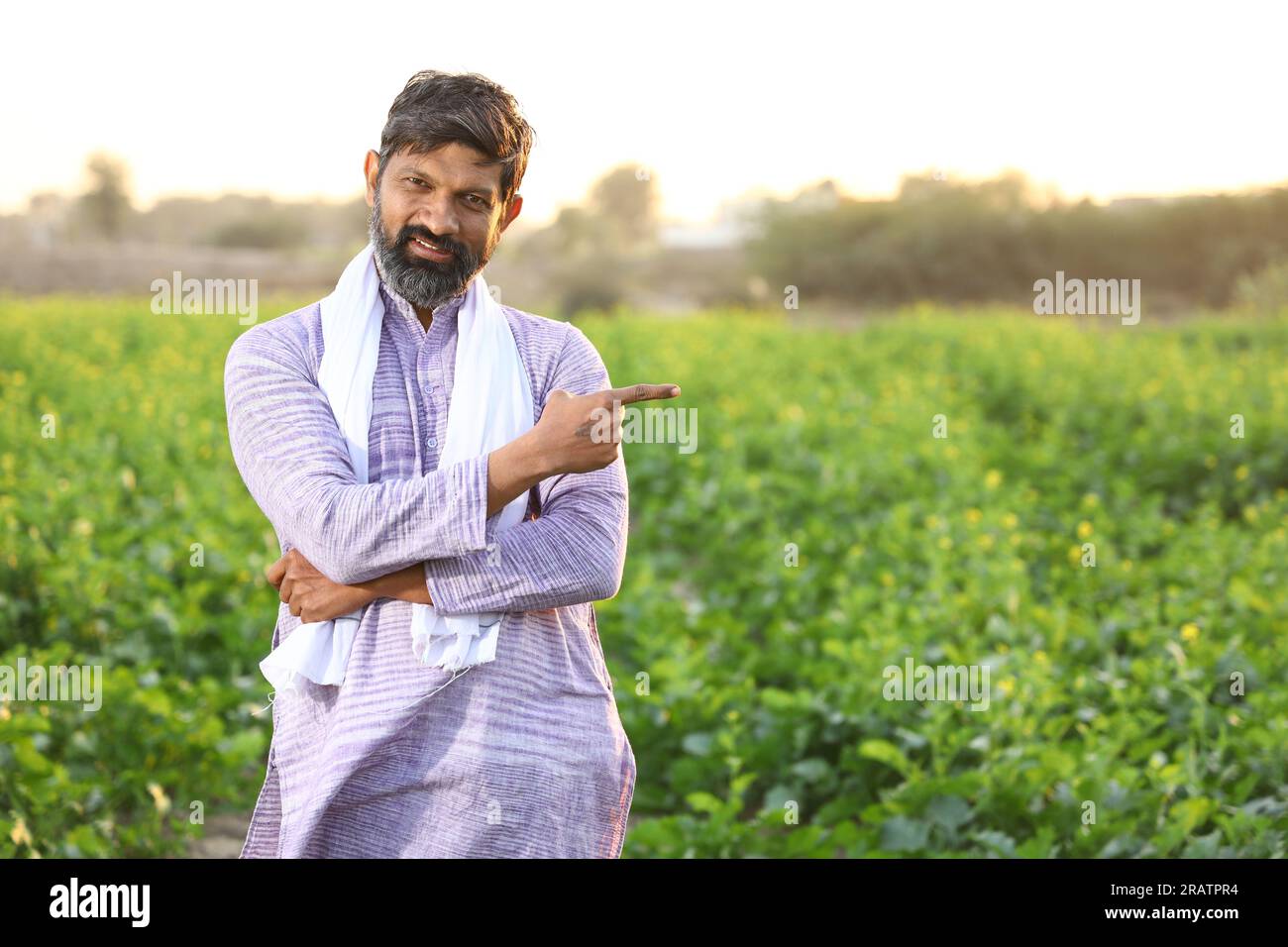 Portrait of Happy Indian farmer feeling the wind while standing in ...