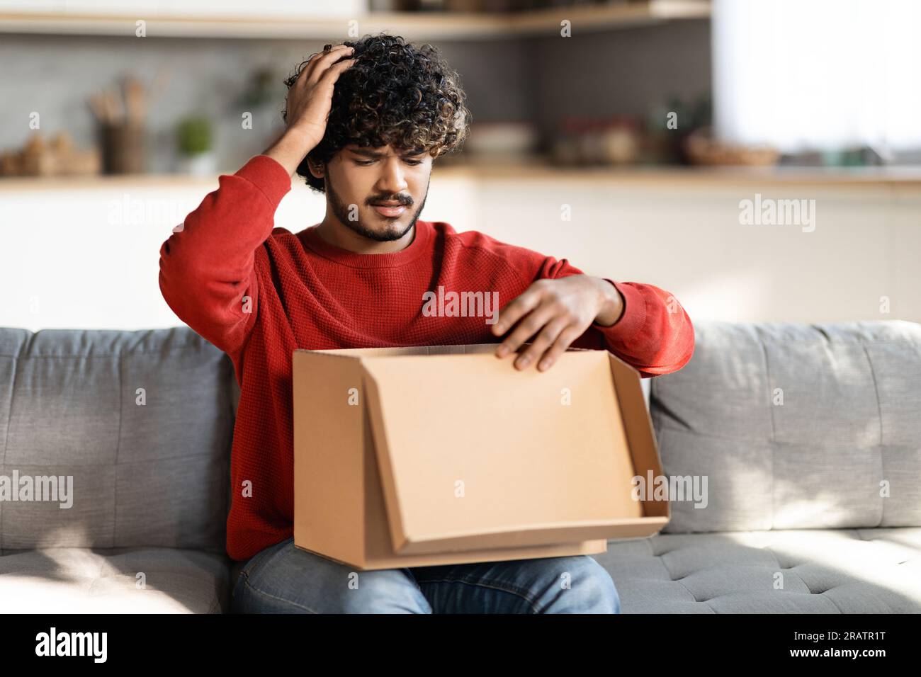 Upset Indian Man Opening Post Parcel And Touching Head In Shock Stock ...