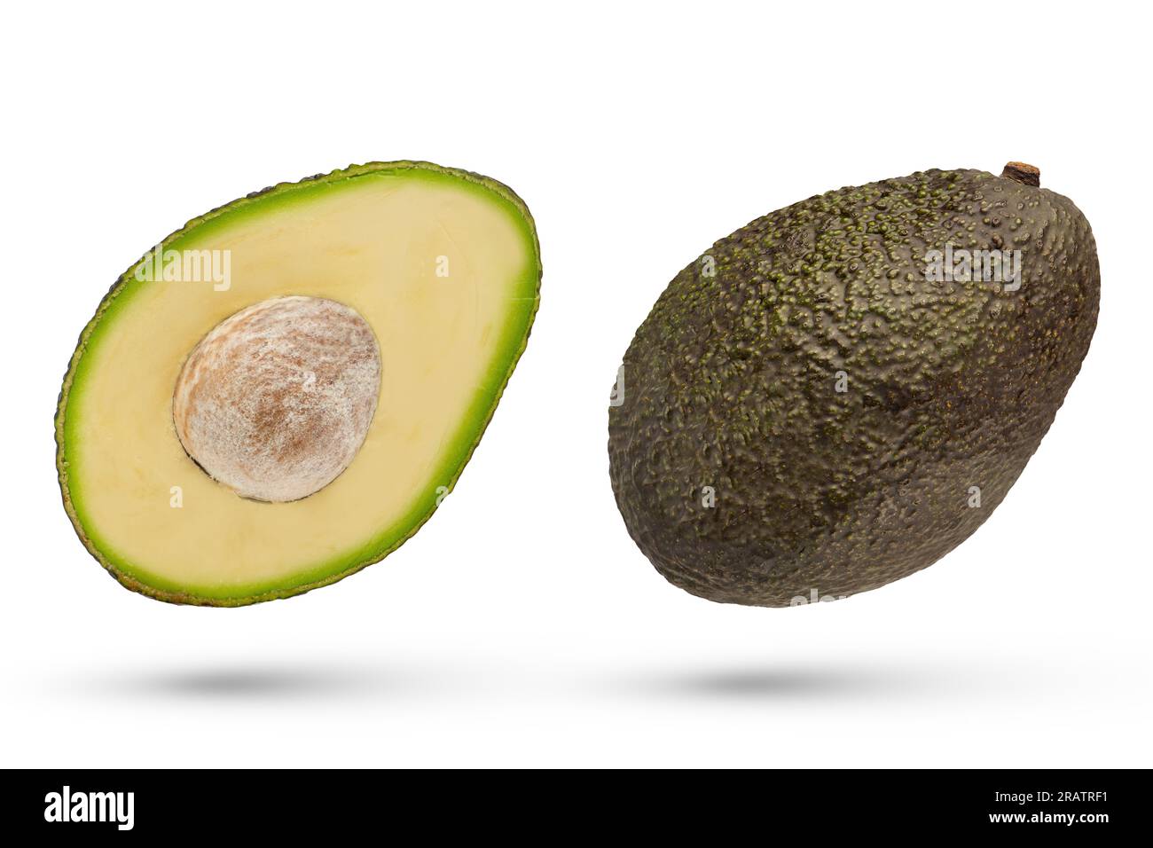 Falling avocado divided into parts isolated on white background ...