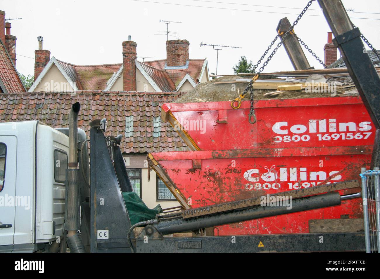 Two bright red skips marked Collins on the back of a lorry Stock Photo ...