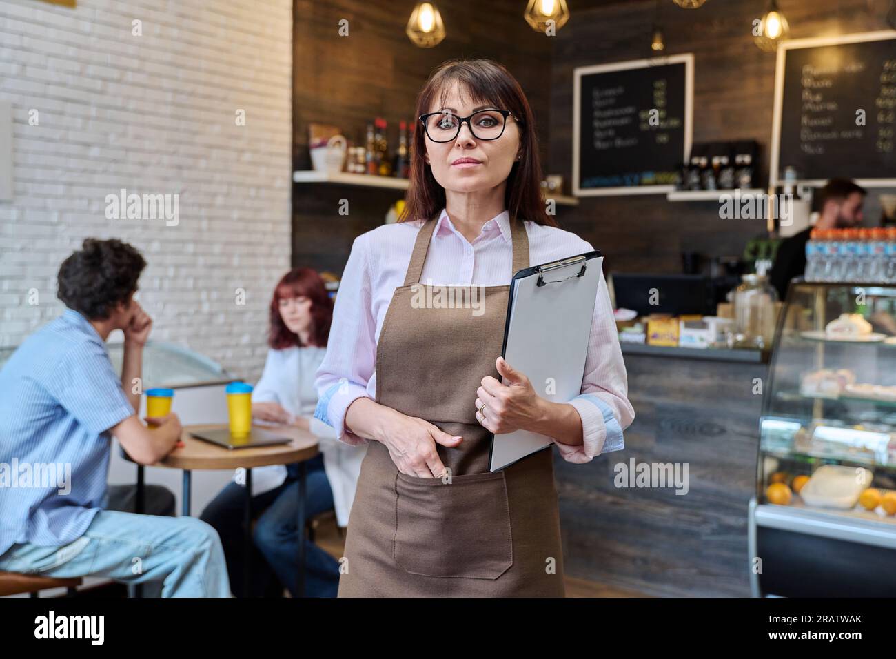Portrait of confident middle aged woman coffee shop owner Stock Photo ...