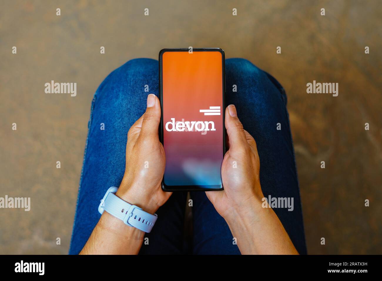 In this photo illustration, the Devon Energy logo is displayed on a ...