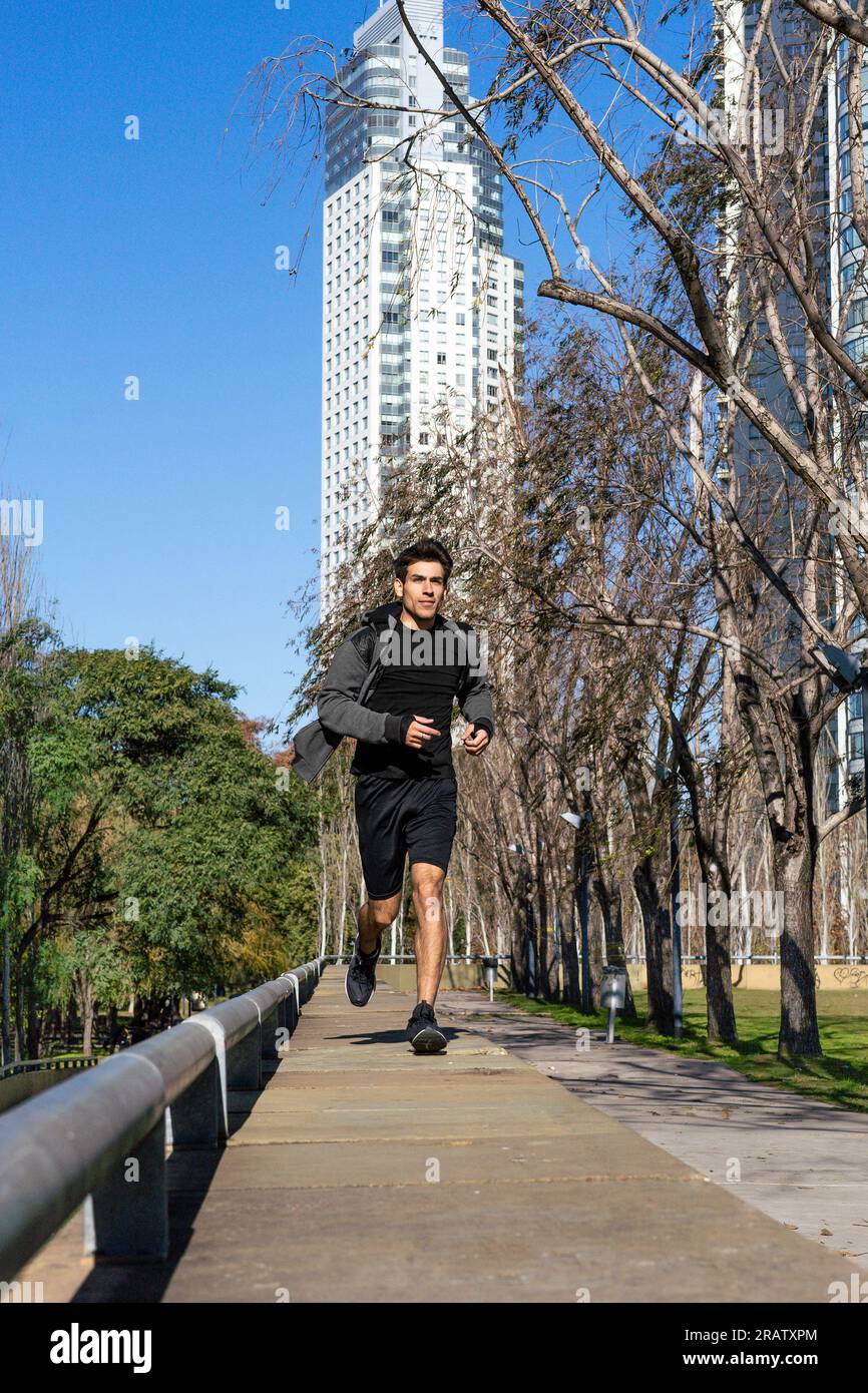 Fitness athlete runner jogging on park sidewalk. Copy space Stock Photo ...