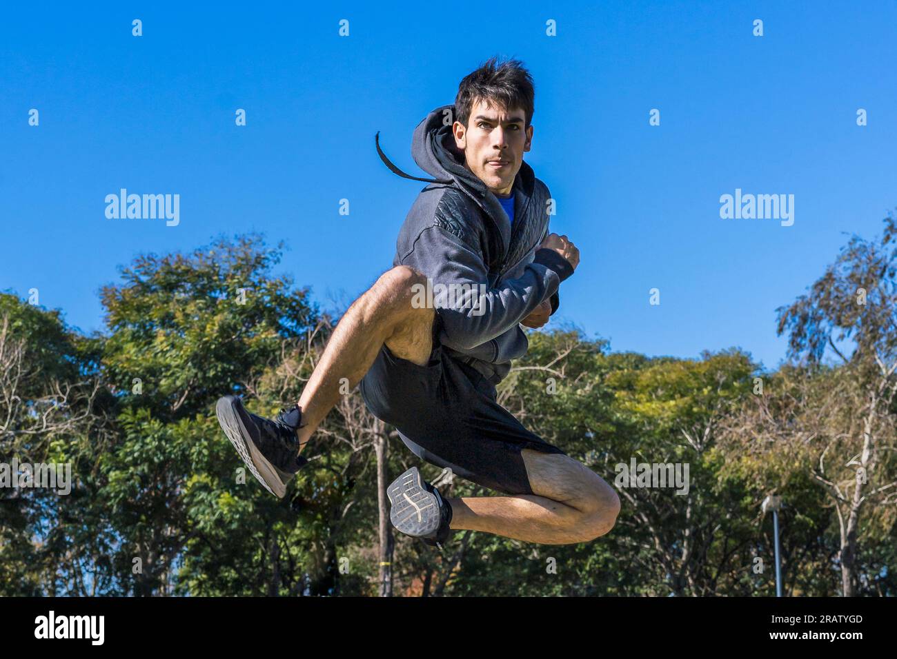 Martial arts fighter jumping in fly outdoors Stock Photo - Alamy