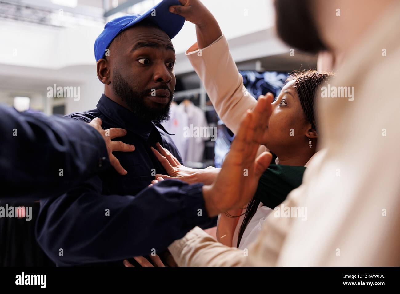 Mad rude diverse people pushing shocked African American man security ...