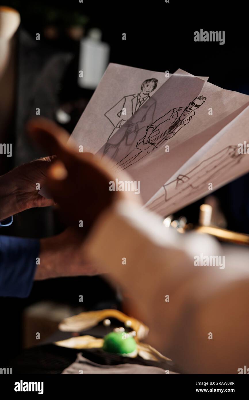 Close up of technical sketch representations of stylish bespoke sartorial pieces in atelier shop ...