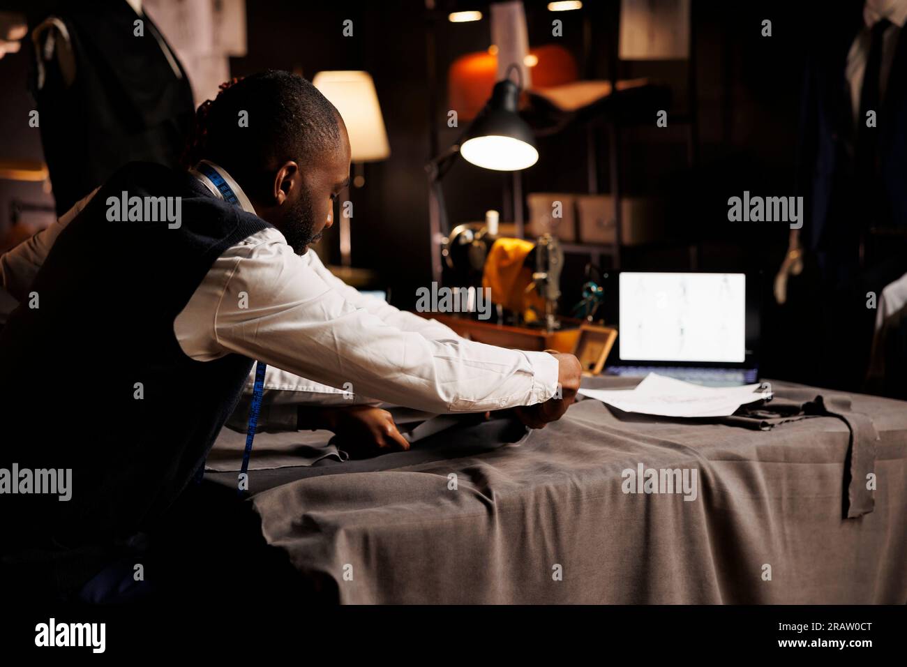 Precise craftmanship in tailoring studio by african american suitmaker ...