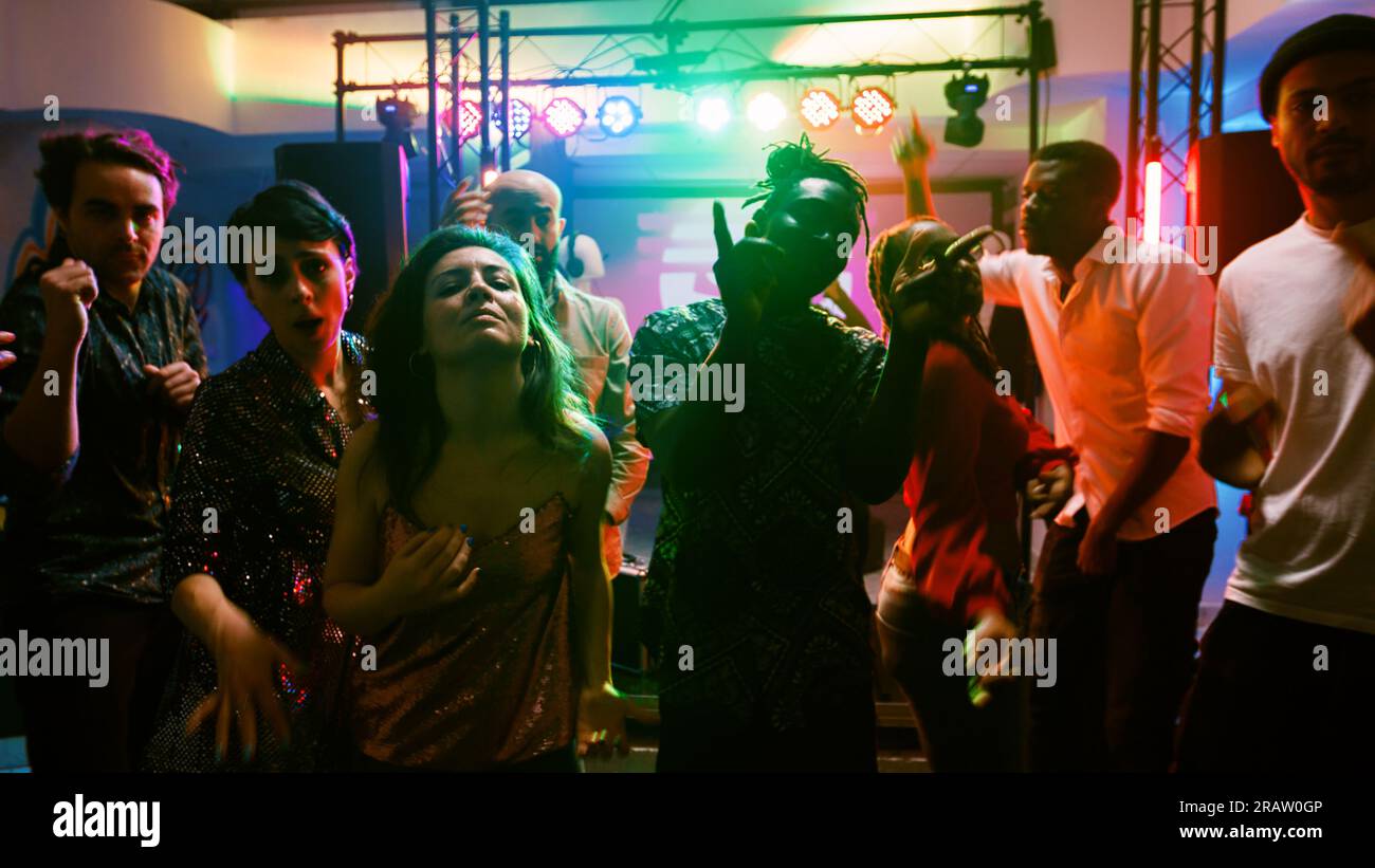 POV of diverse adults partying at club, doing funky dance moves on ...