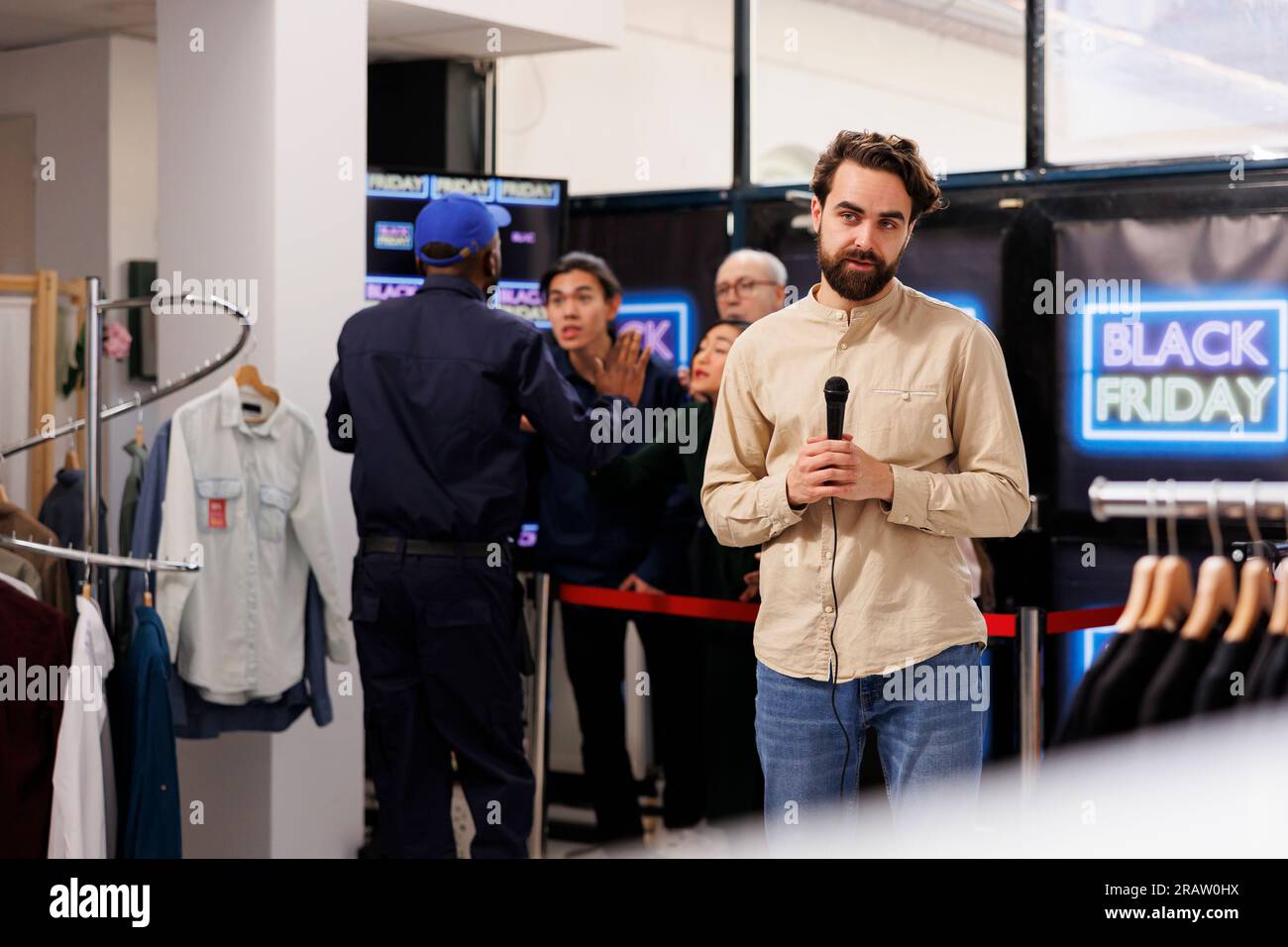 TV reporter working at shopping mall for live shot of people lining up ...