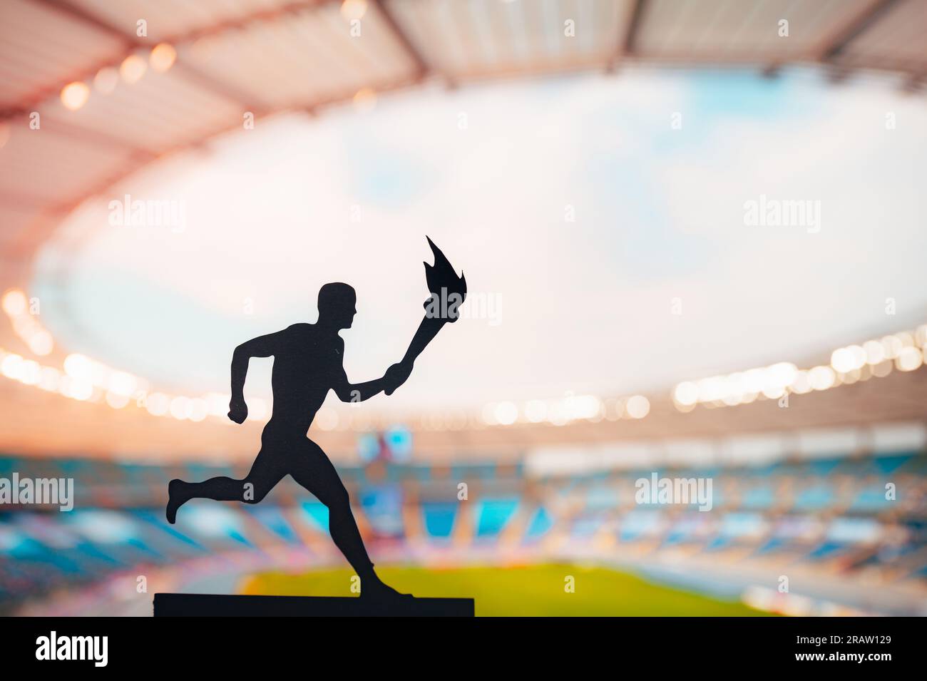 Igniting the Spirit: Silhouette of Male Athlete Carrying the Torch ...