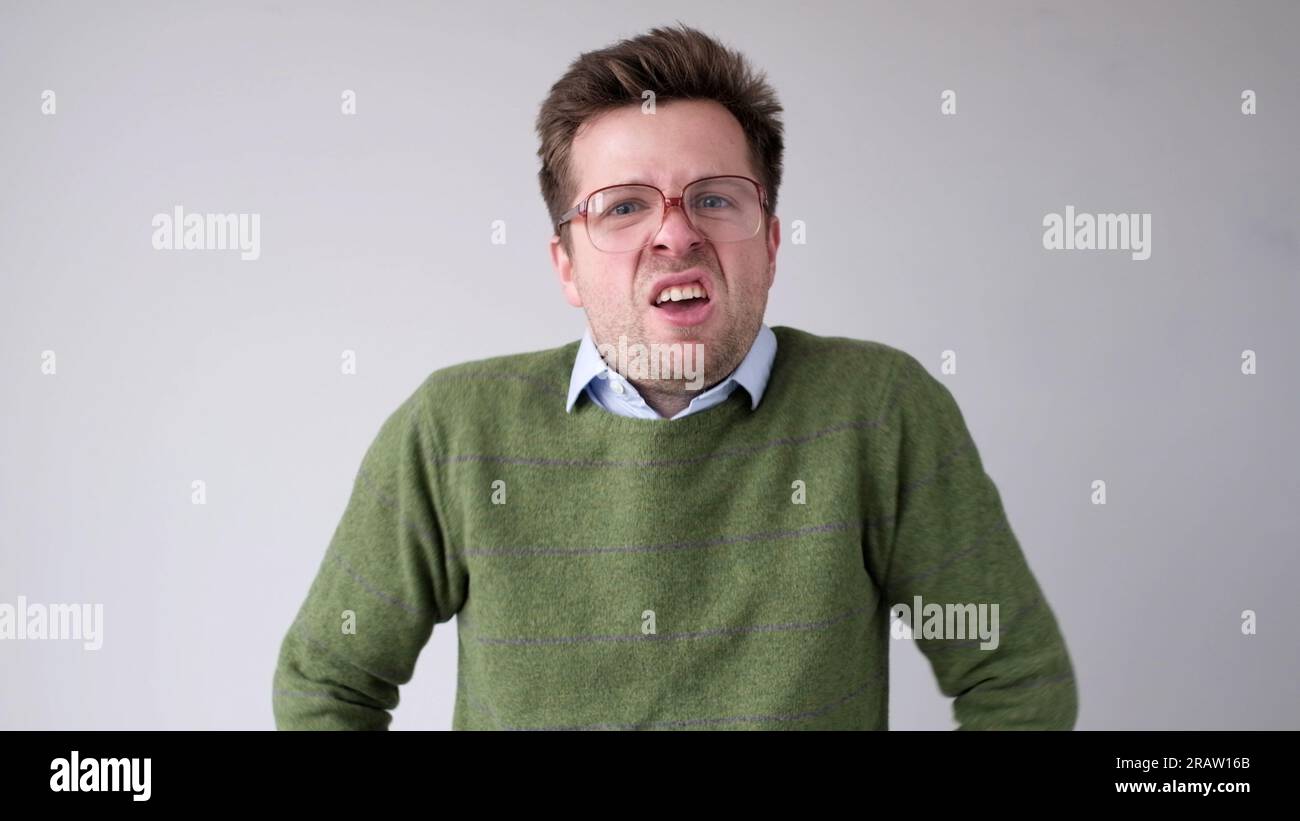 The angry European young man wearily looks. He is without strength and ...