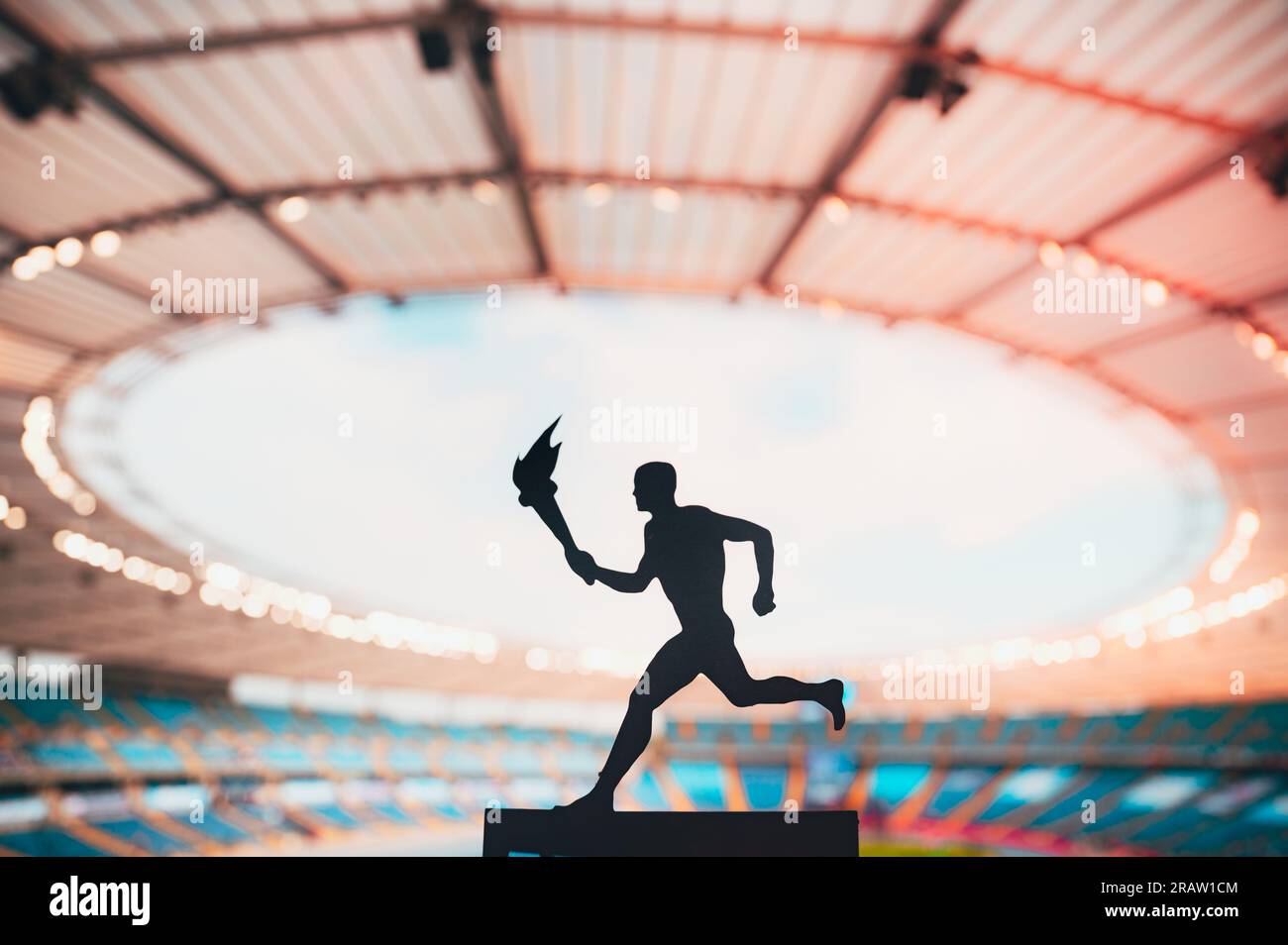 Silhouette of Athlete Holding the Torch Relay, Set against a Modern ...