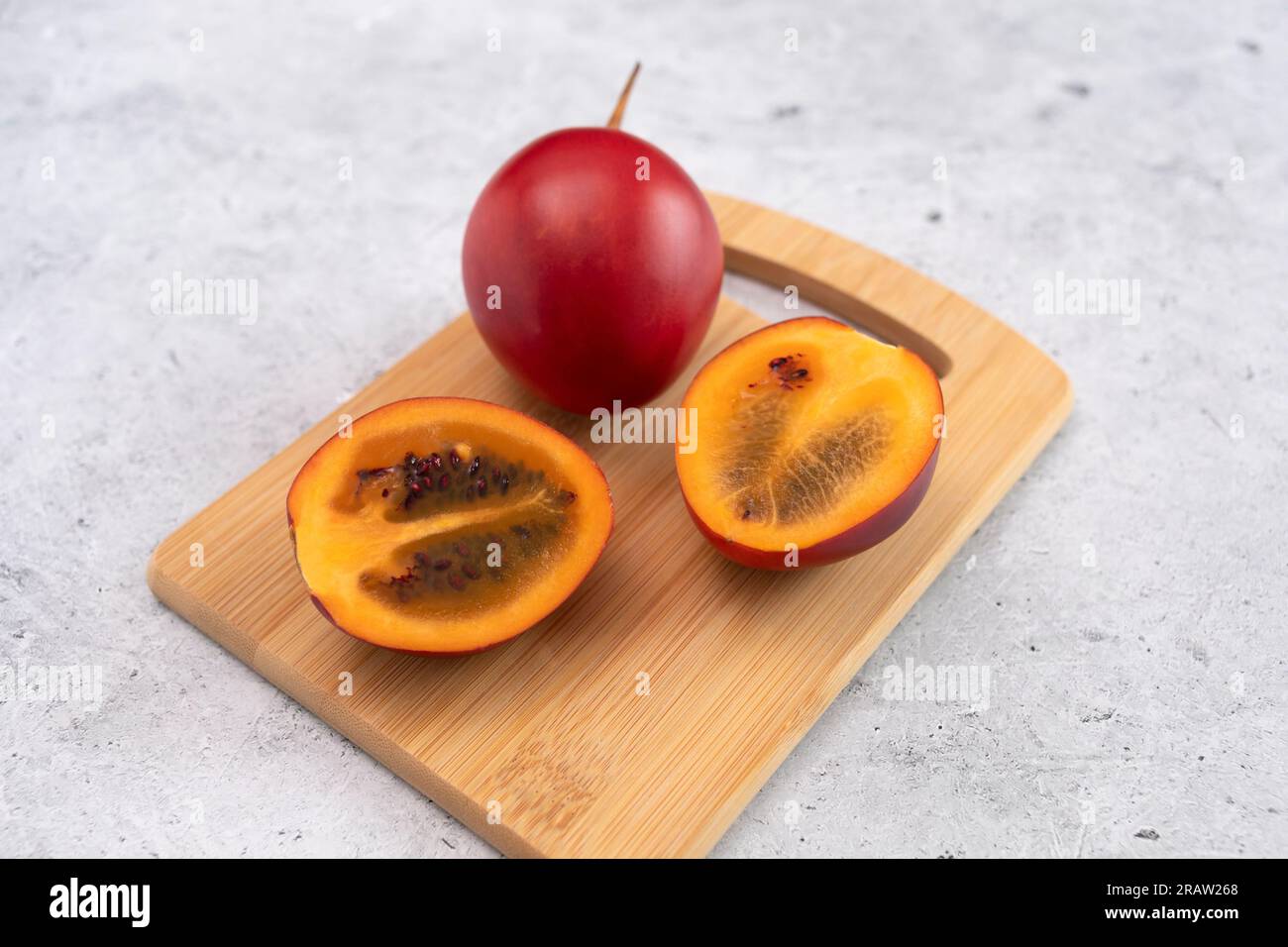 Fresh Exotic Fruit Tamarillo Sliced On Wooded Cutting Board On Table ...