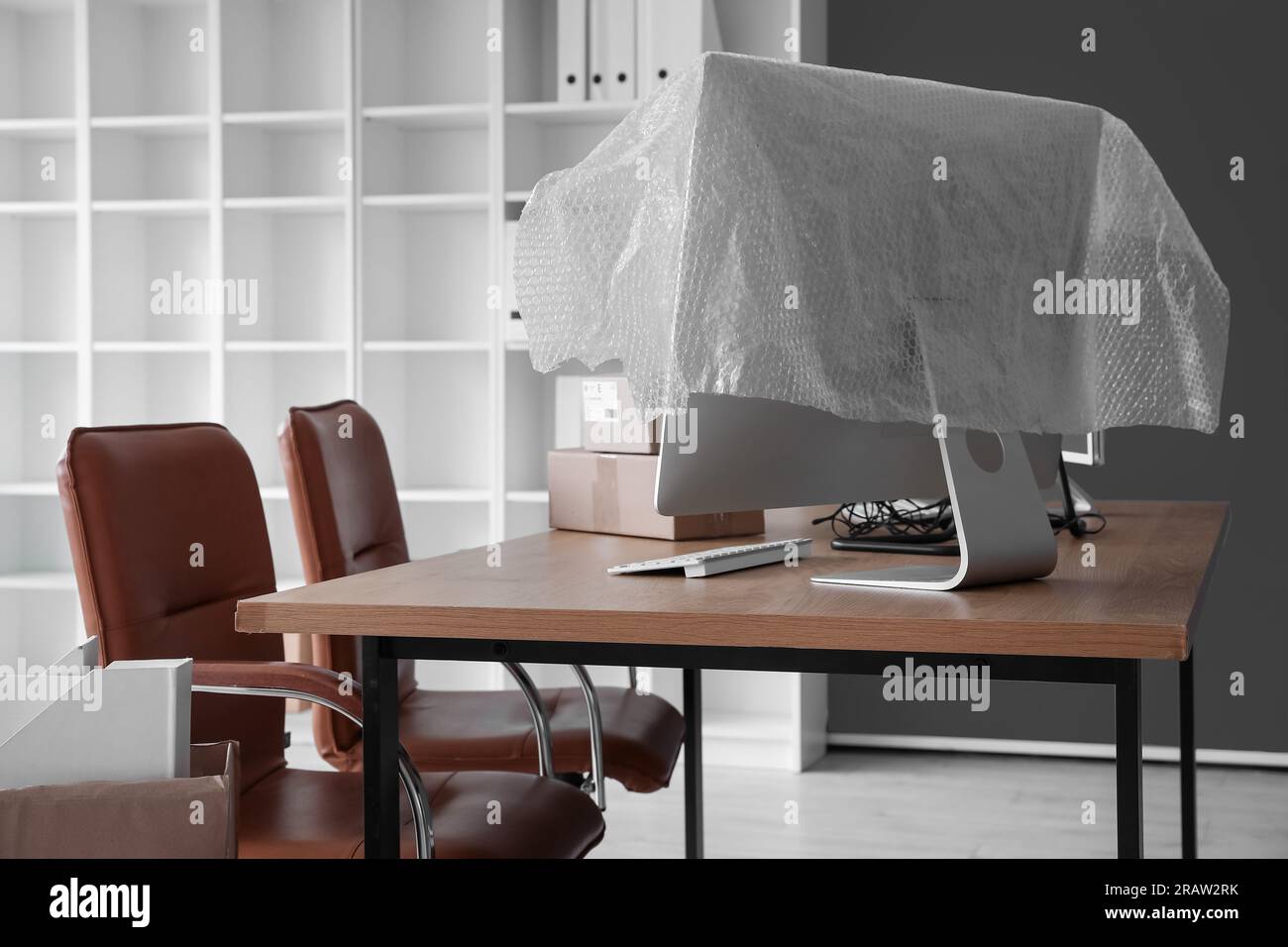 Workplace with cardboard boxes in office on moving day Stock Photo - Alamy