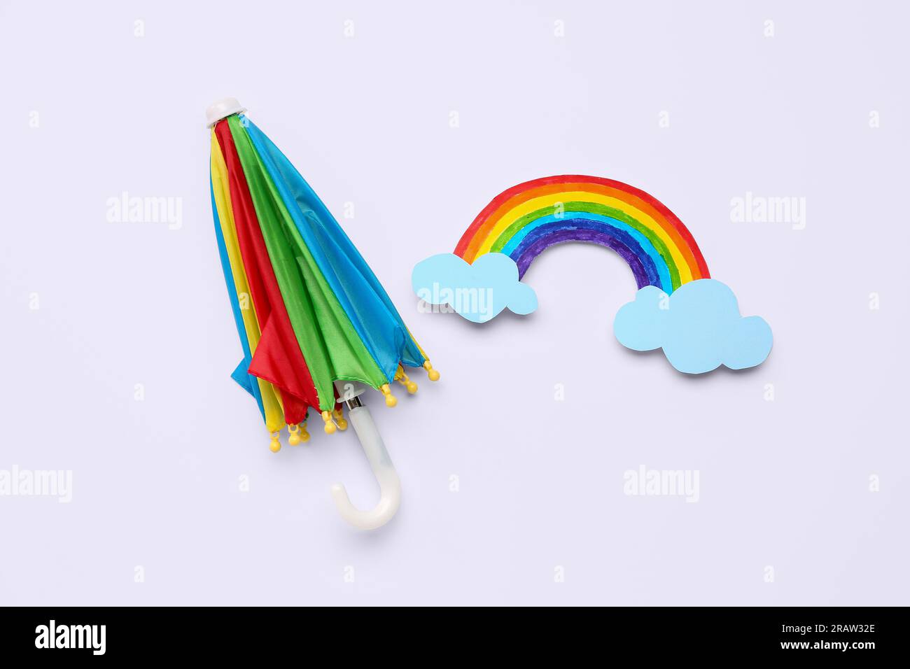 Paper rainbow with umbrella on white background. Weather forecast ...