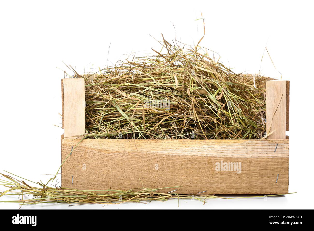 Straw in crate on white background Stock Photo - Alamy